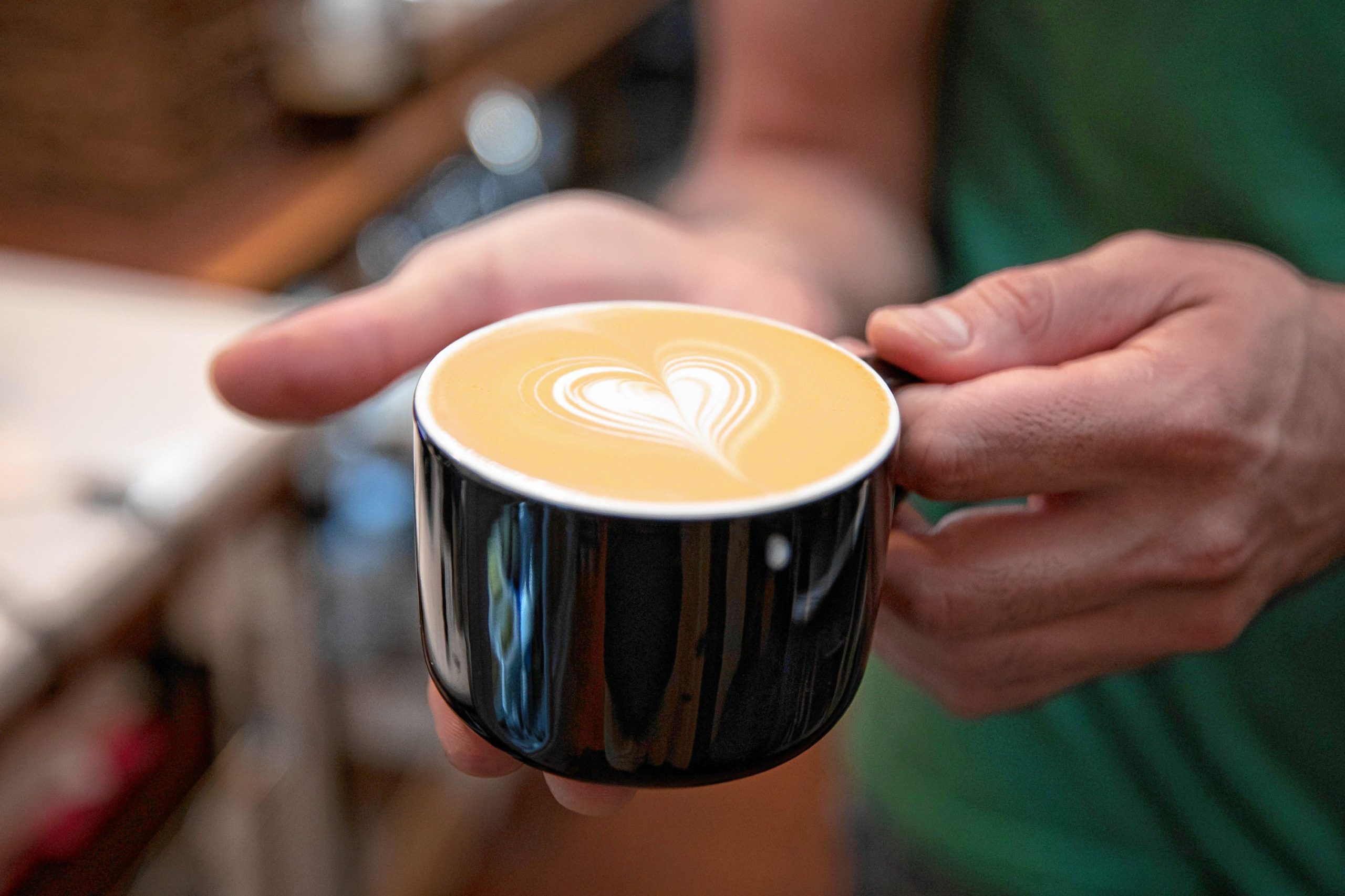 Cafe Balagan co-owner and manager Gill Sasson prepares a drink on ...